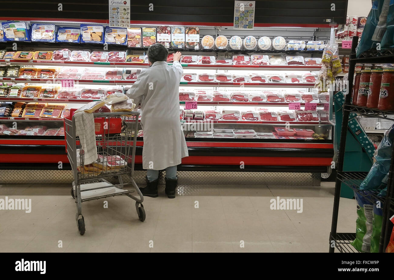 A worker stocks the meat department in a supermarket in New York on ...