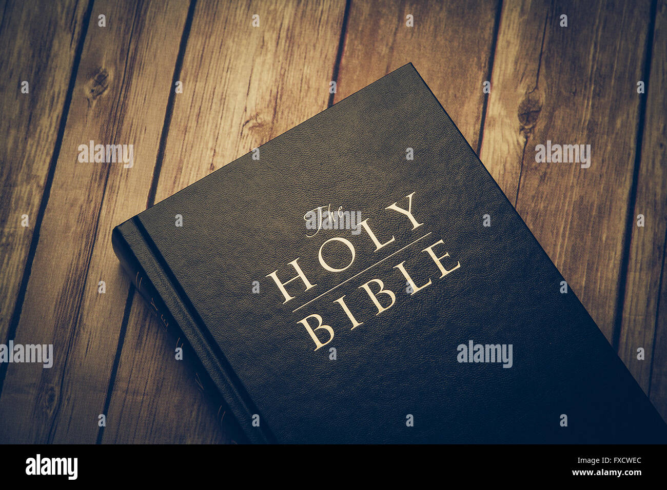 The Holy Bible on a wooden table Stock Photo - Alamy