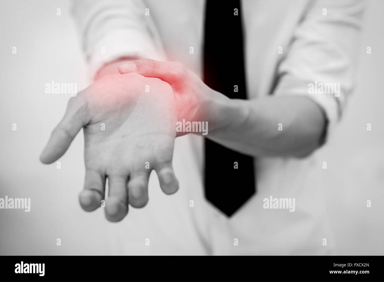Office Man touching painful wrist. Pain in a man wrist Stock Photo - Alamy