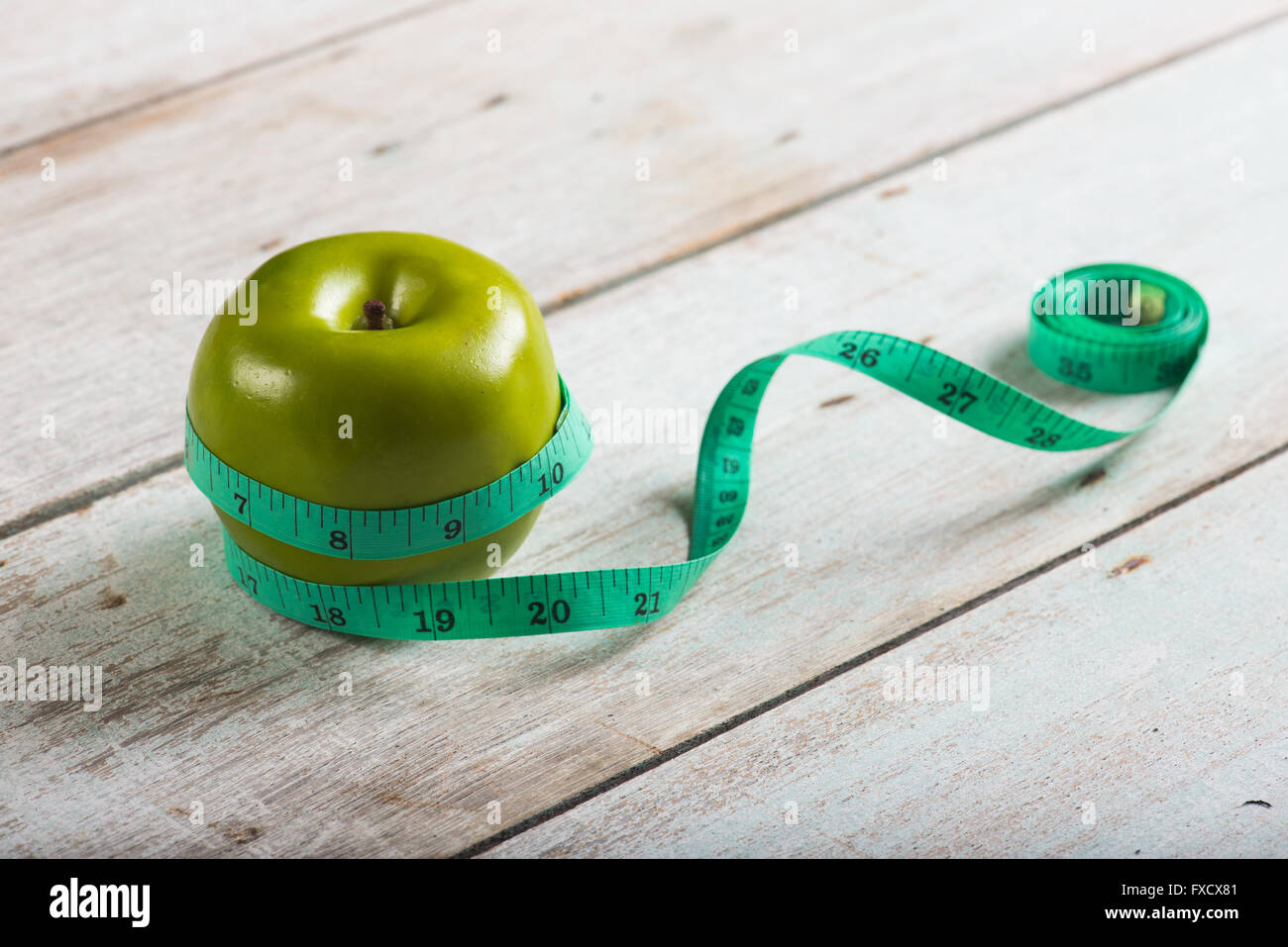 Green apples measured the meter on a white Stock Photo - Alamy