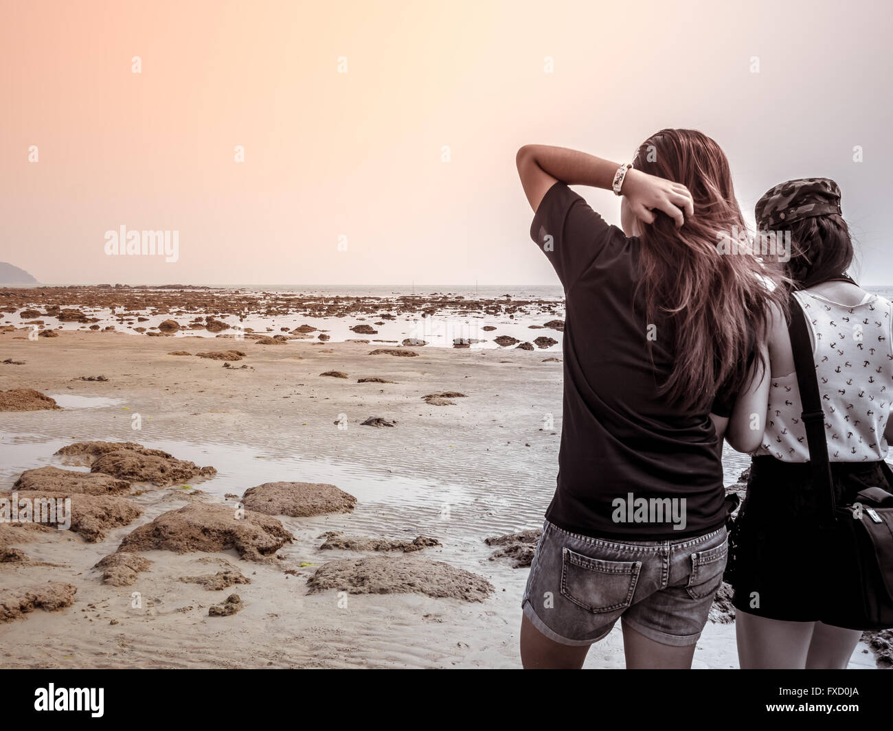 Friends looking off into the distant sunset Stock Photo - Alamy