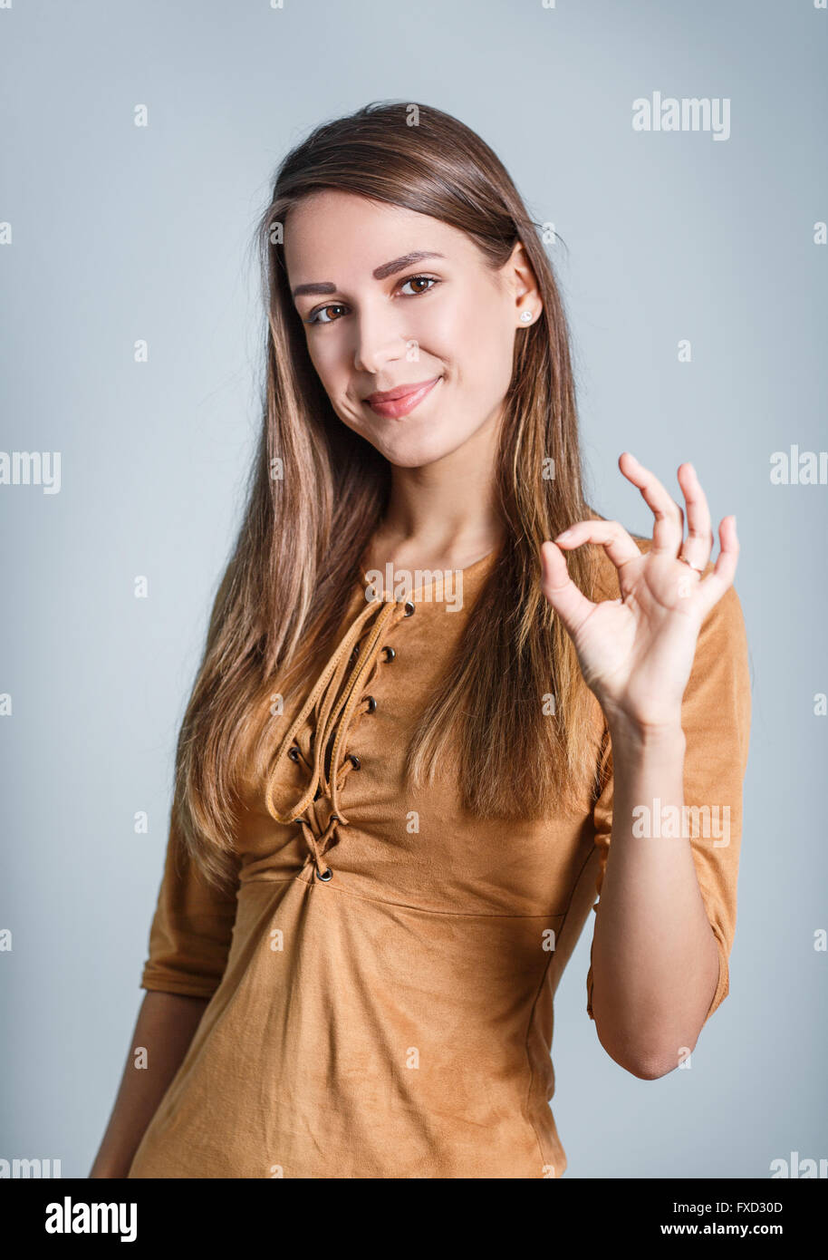Young beautiful woman shows OK sign Stock Photo - Alamy