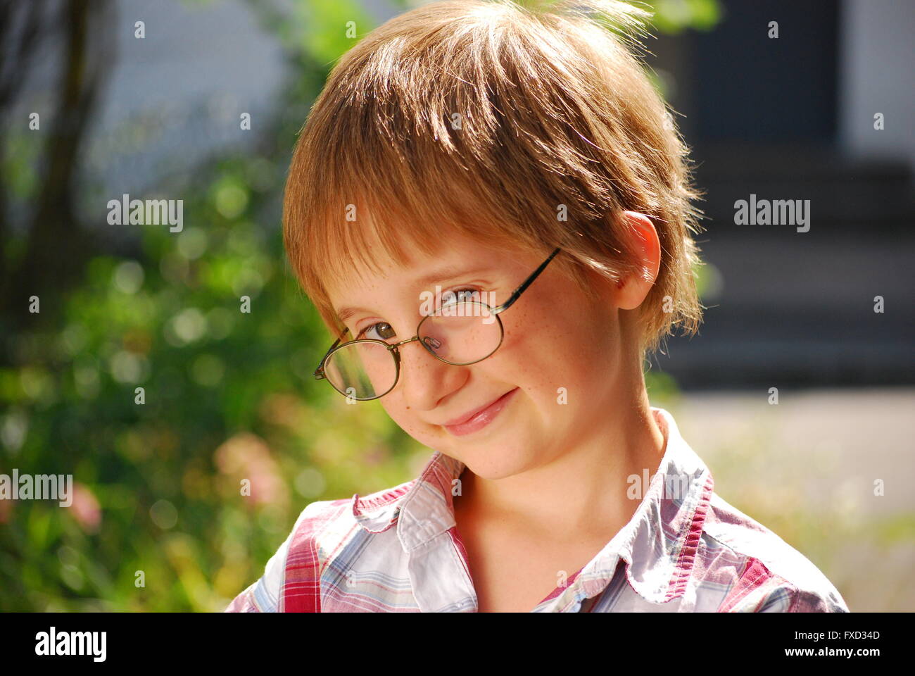 A boy smiles at the camera for an outdoors portrait Stock Photo - Alamy