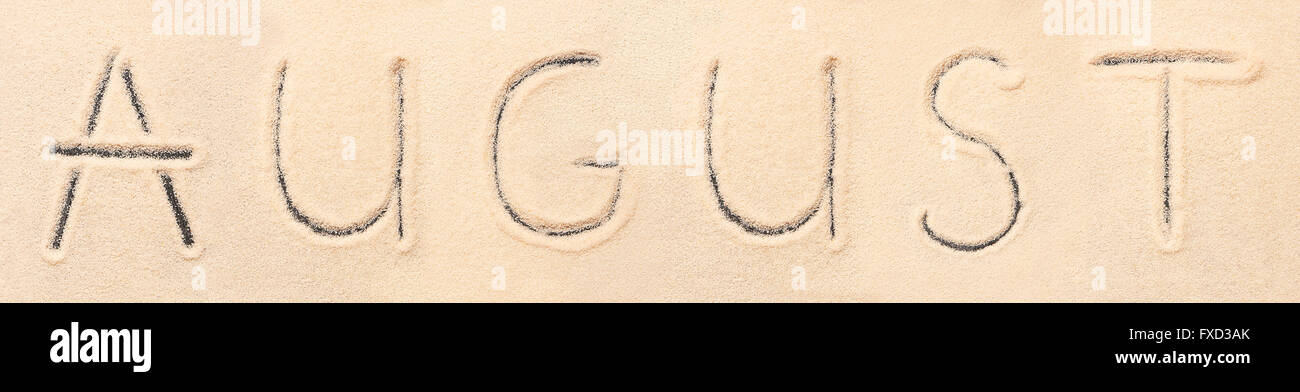 August lettering drawn on sand. Summer beach background Stock Photo - Alamy