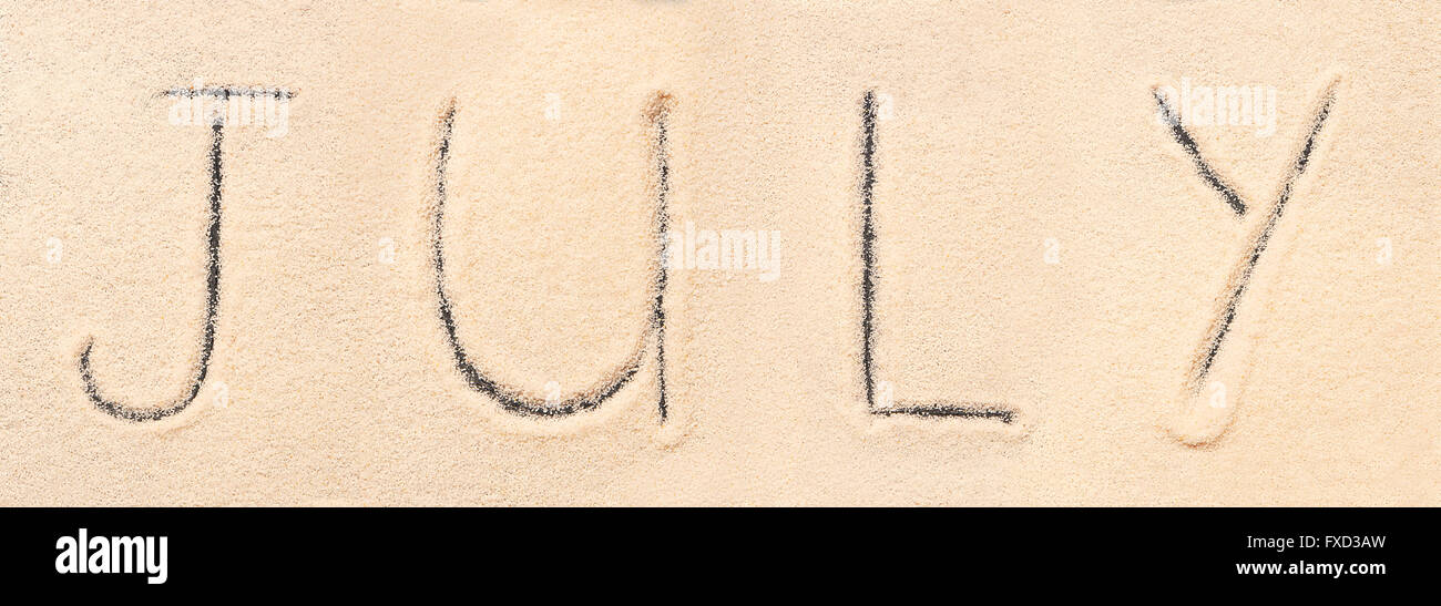 July lettering drawn on sand. Summer beach background Stock Photo - Alamy