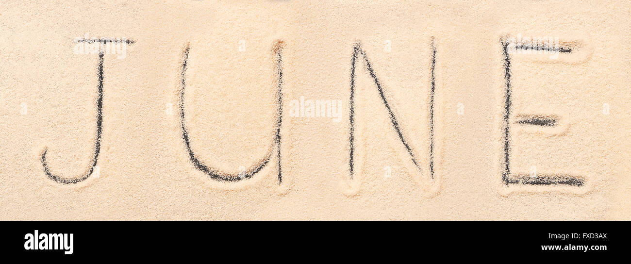 June lettering drawn on sand. Summer beach background Stock Photo - Alamy