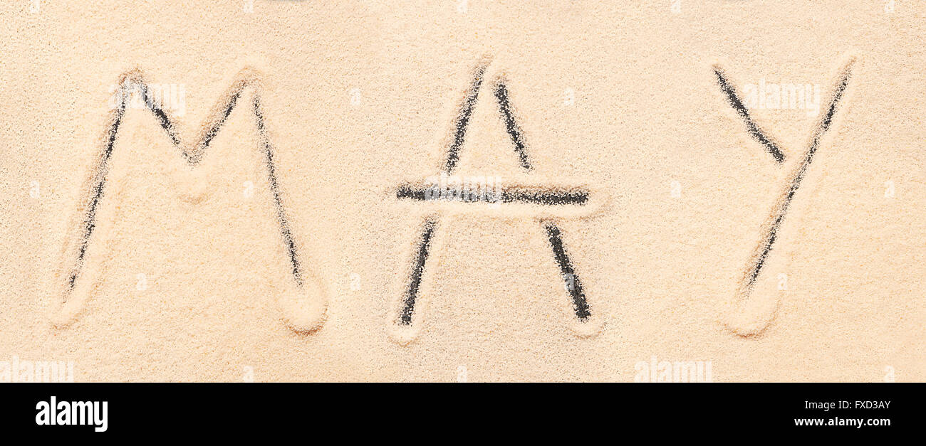 May lettering drawn on sand. Summer beach background Stock Photo - Alamy