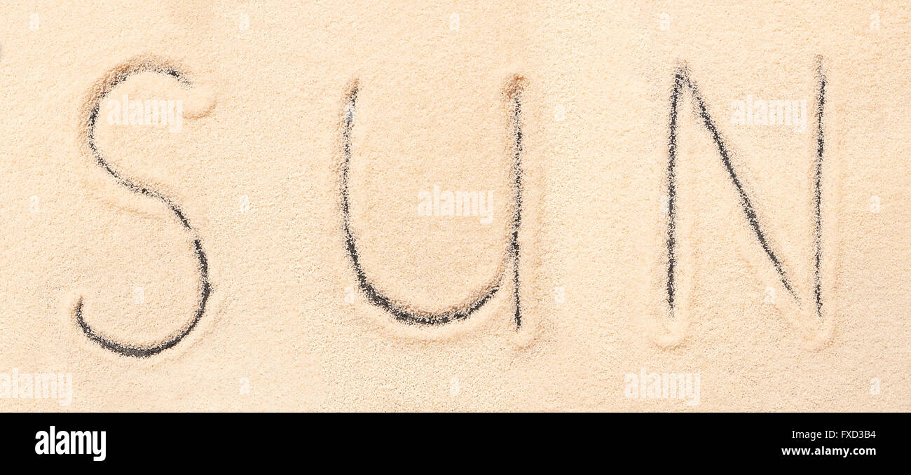 Sun lettering drawn on sand. Summer beach background Stock Photo - Alamy