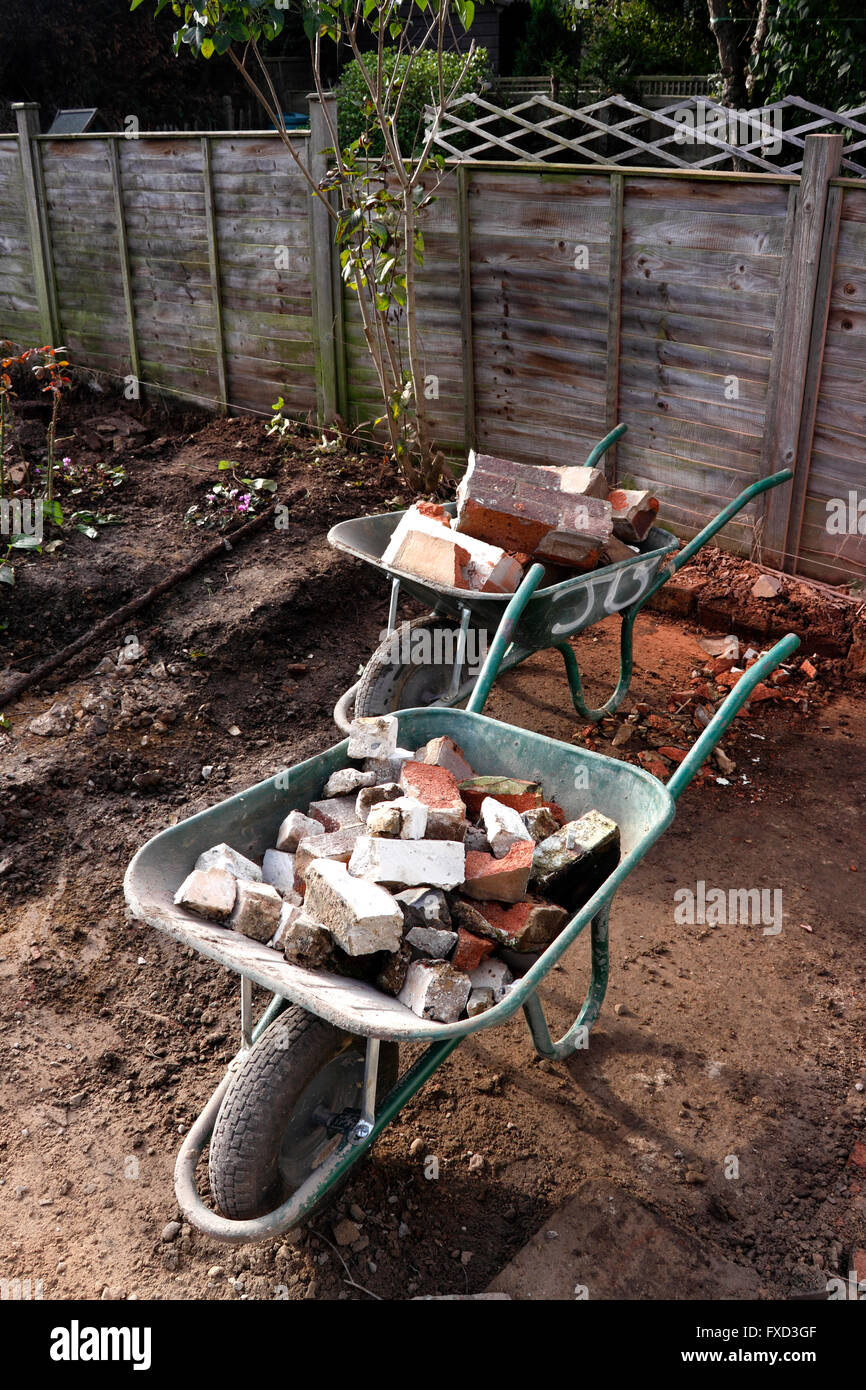 BUILDERS WHEELBARROWS WITH BRICK RUBBLE. UK Stock Photo - Alamy