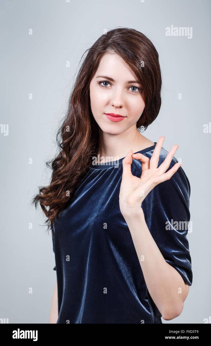Young beautiful woman shows OK sign Stock Photo - Alamy