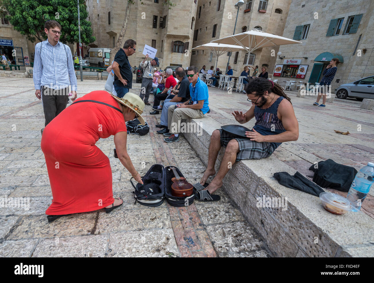 Man playing on kind of hang drum on square in front of Hurva Synagogue ...