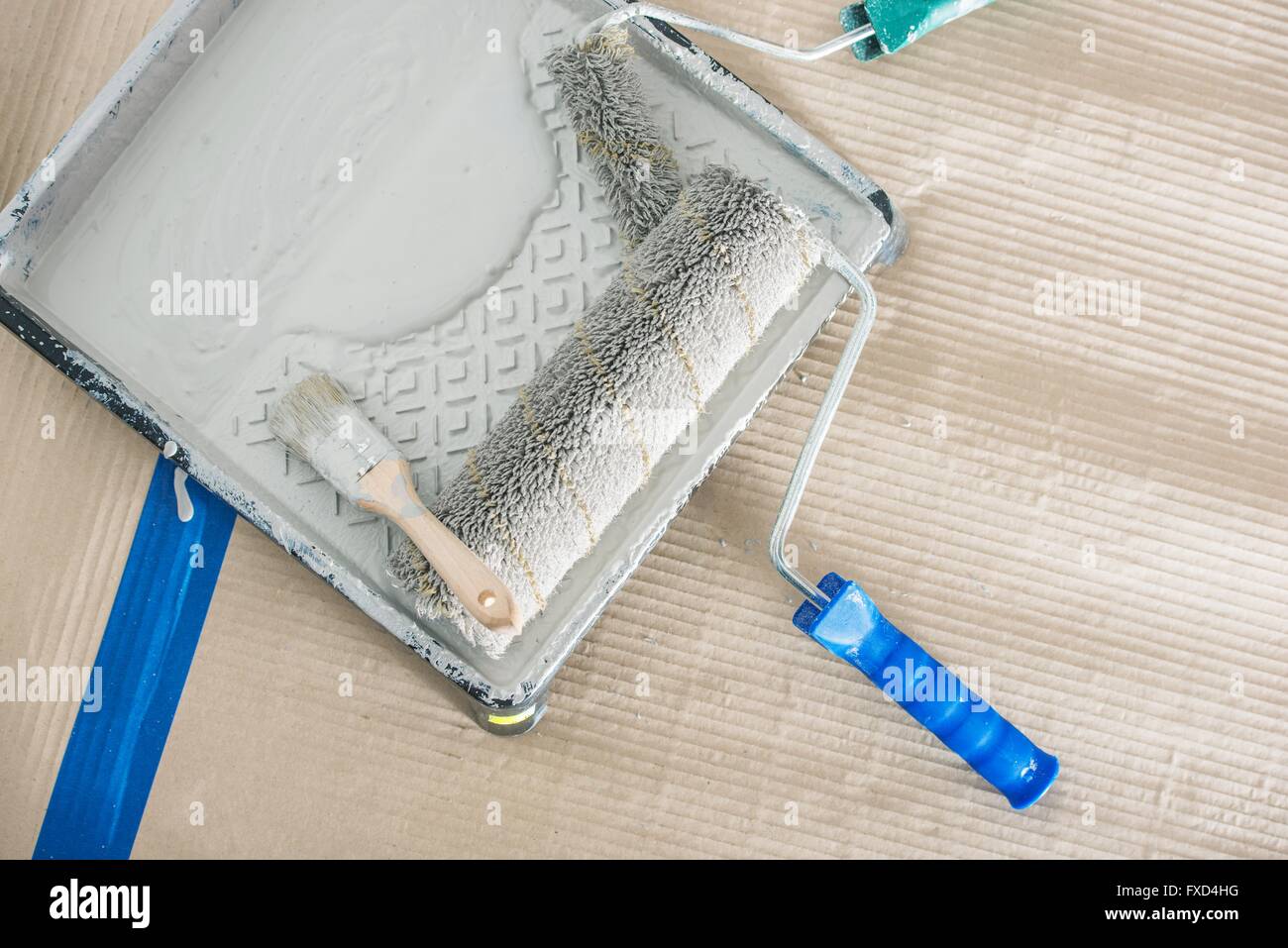 Roller Painting Equipment. White Paint in the Container with Roller and ...