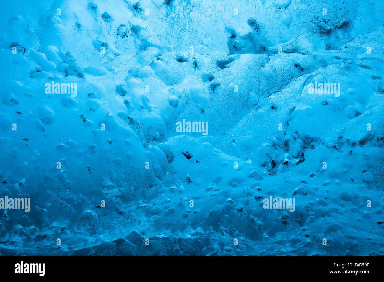 Blue ice mixed with volcanic ash in ice cavern inside ...