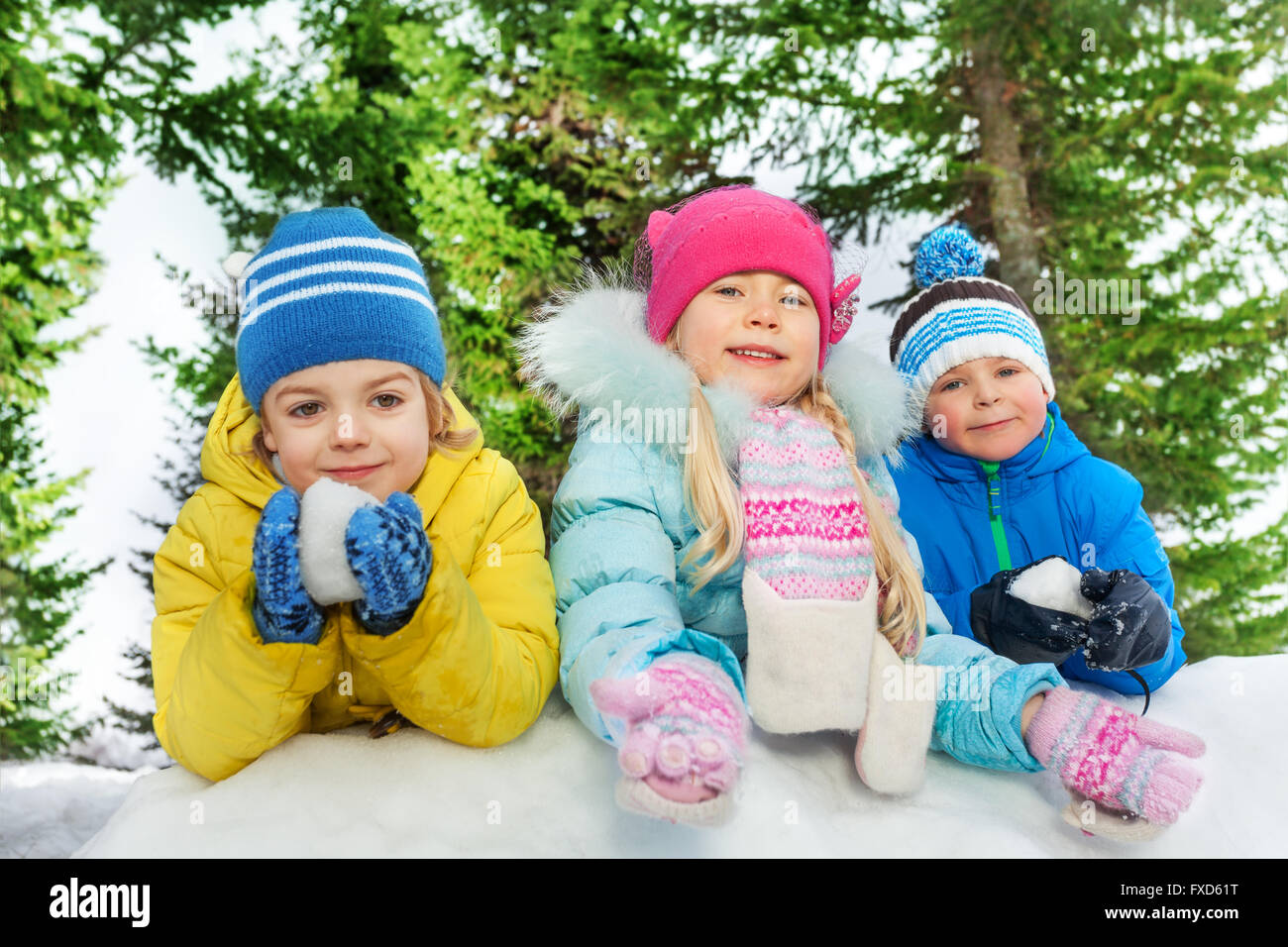 Kids play with snow together close portrait Stock Photo - Alamy