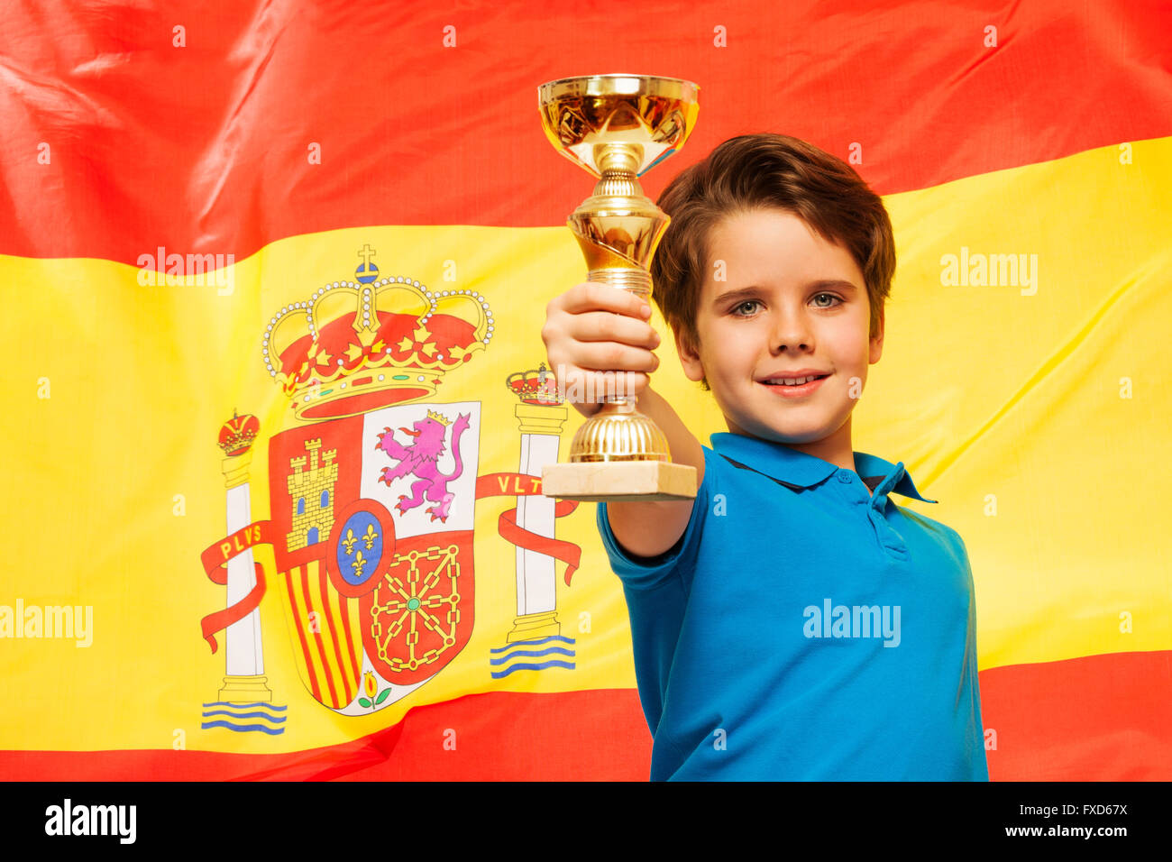 Happy winner with his cup against a flag of Spain Stock Photo - Alamy