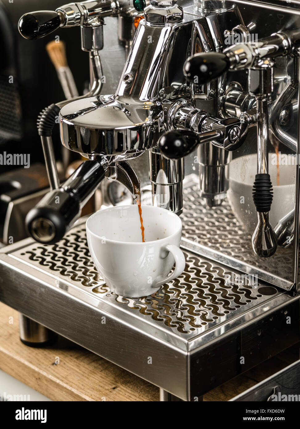 Photo of an espresso being made with a professional coffee machine ...