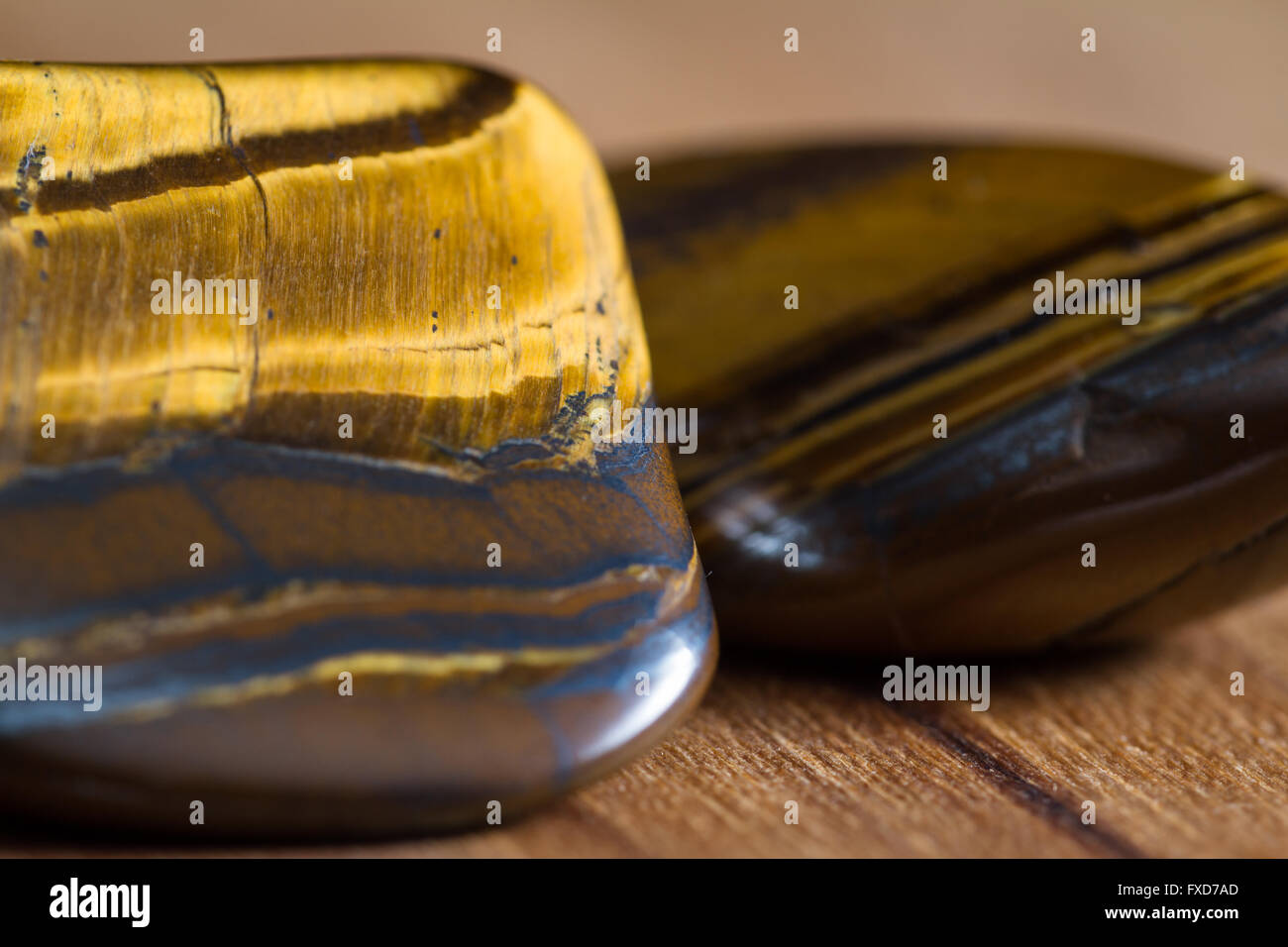 gemstone known as tiger eye or cat eye with a golden color contrasted ...