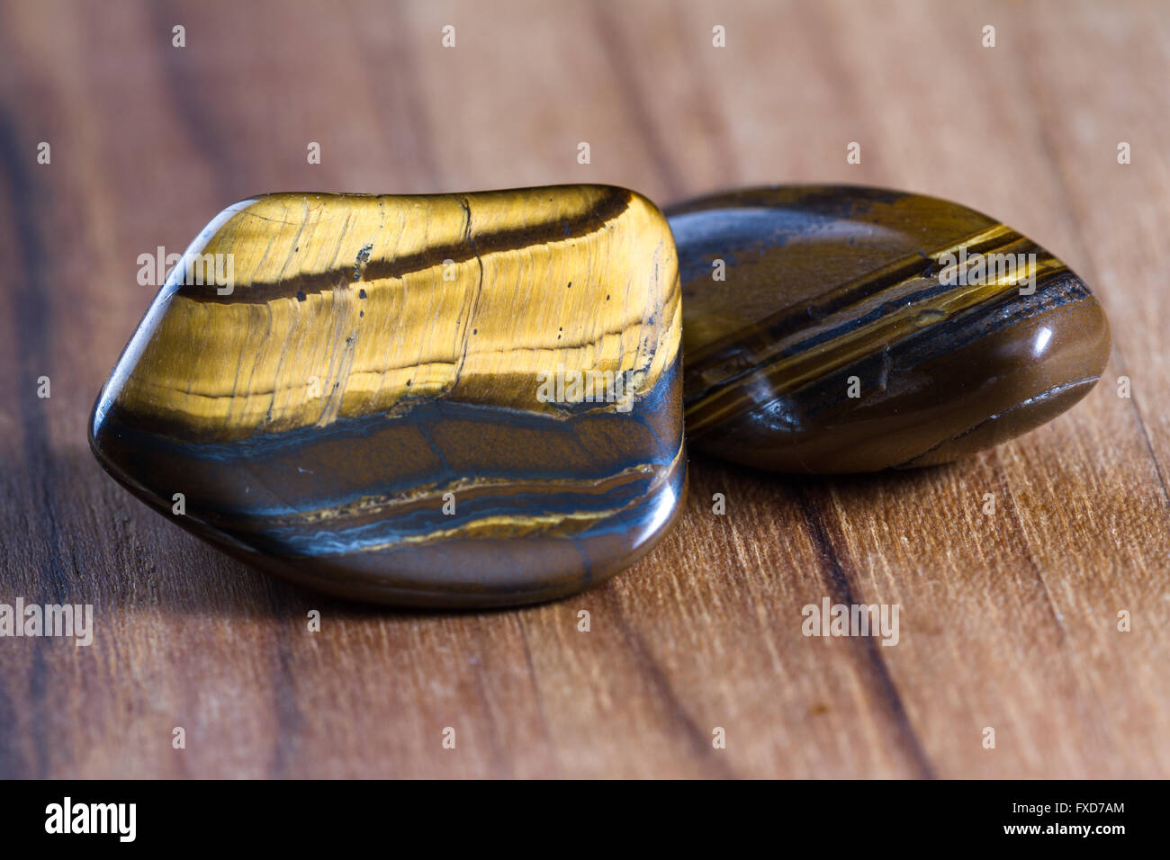 gemstone known as tiger eye or cat eye with a golden color contrasted ...