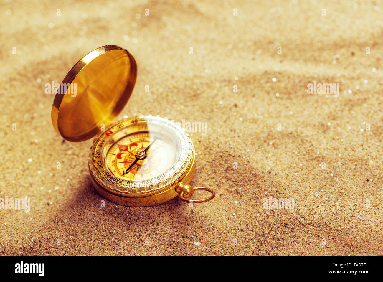 Old compass in dry desert sand, macro shot of vintage navigational ...