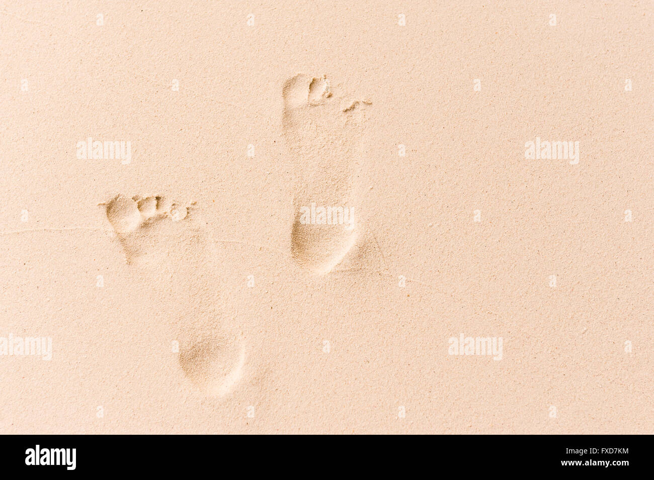Two footprint marks in sand at the beach Stock Photo - Alamy
