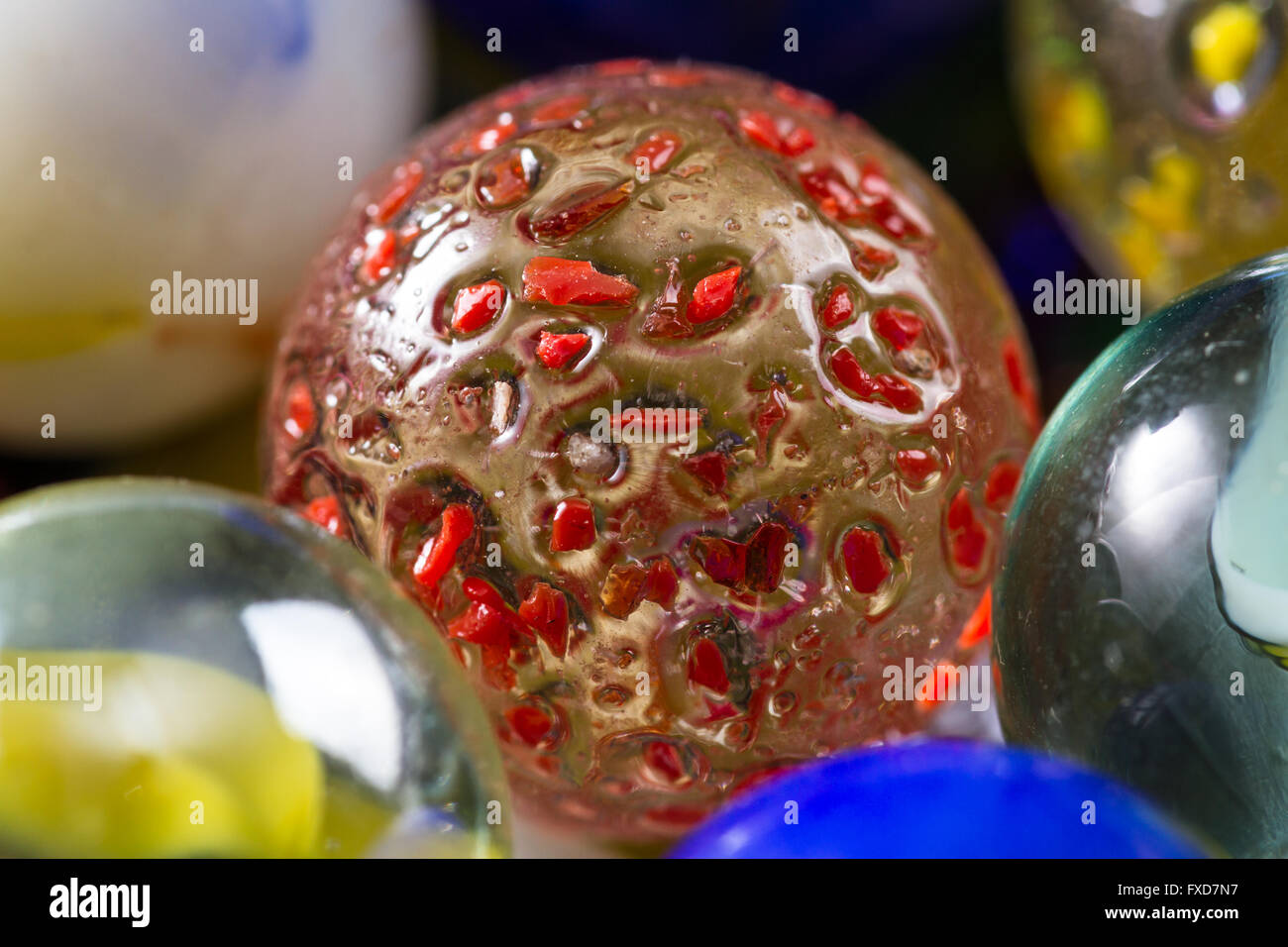 close up of a bunch of marbles in different colors for a background or ...