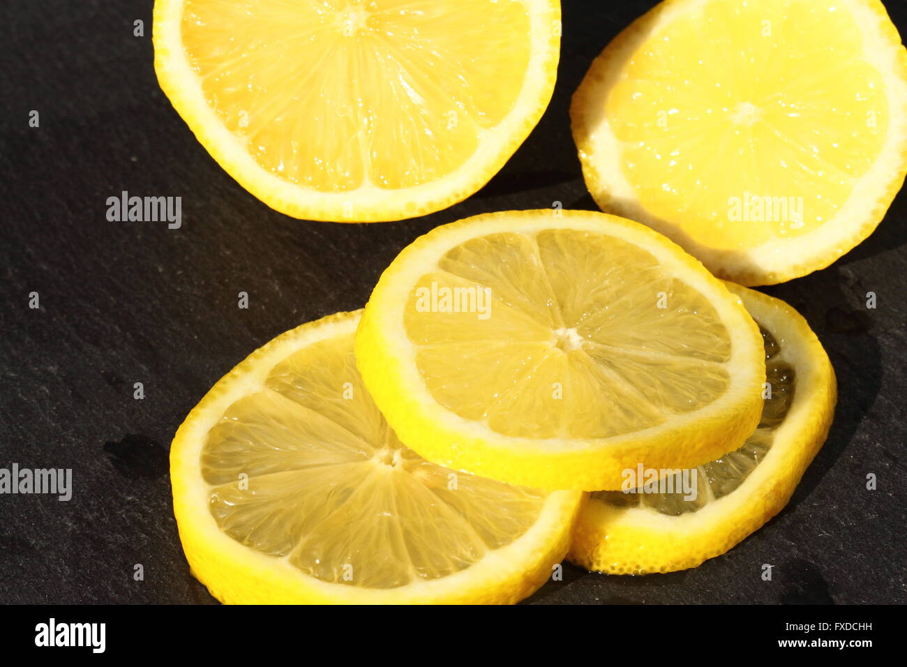 Lemon sliced slate background Stock Photo - Alamy