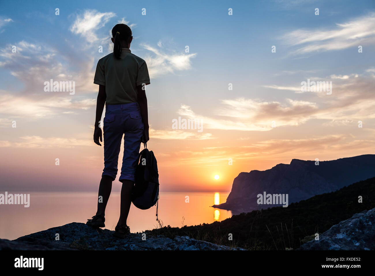 Young woman against sunset Stock Photo - Alamy