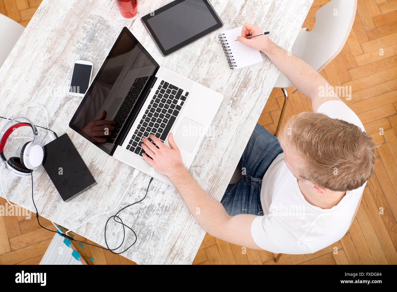 A young caucasian man working in his home office seen from above Stock ...