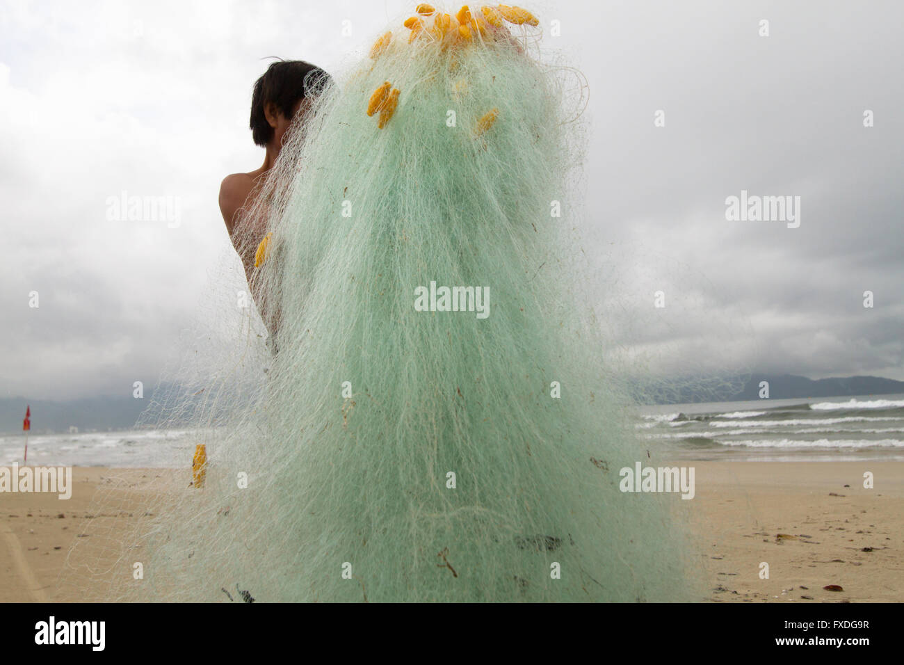 Vietnamese fishermen casting their nets on Danang beach, Vietnam Stock ...