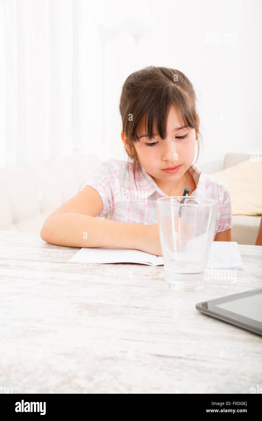 Portrait of daughter doing her homework Stock Photo - Alamy
