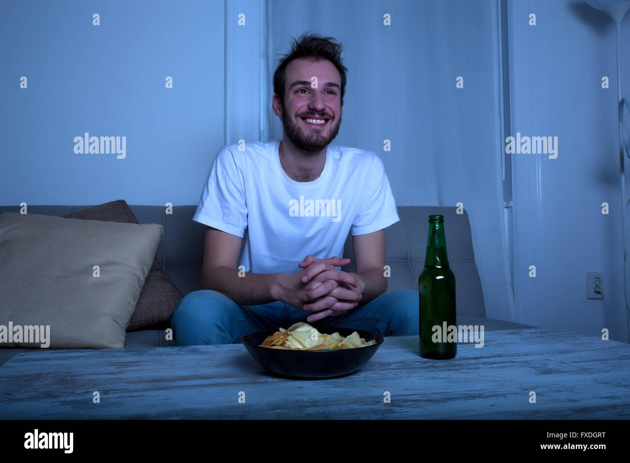 Watching tv alone at nighttime hi-res stock photography and images - Alamy