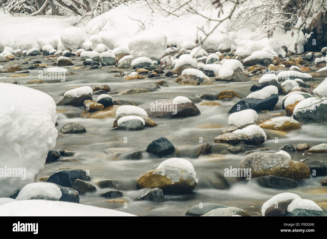 Snow-covered mountain river shot with long exposure Stock Photo - Alamy