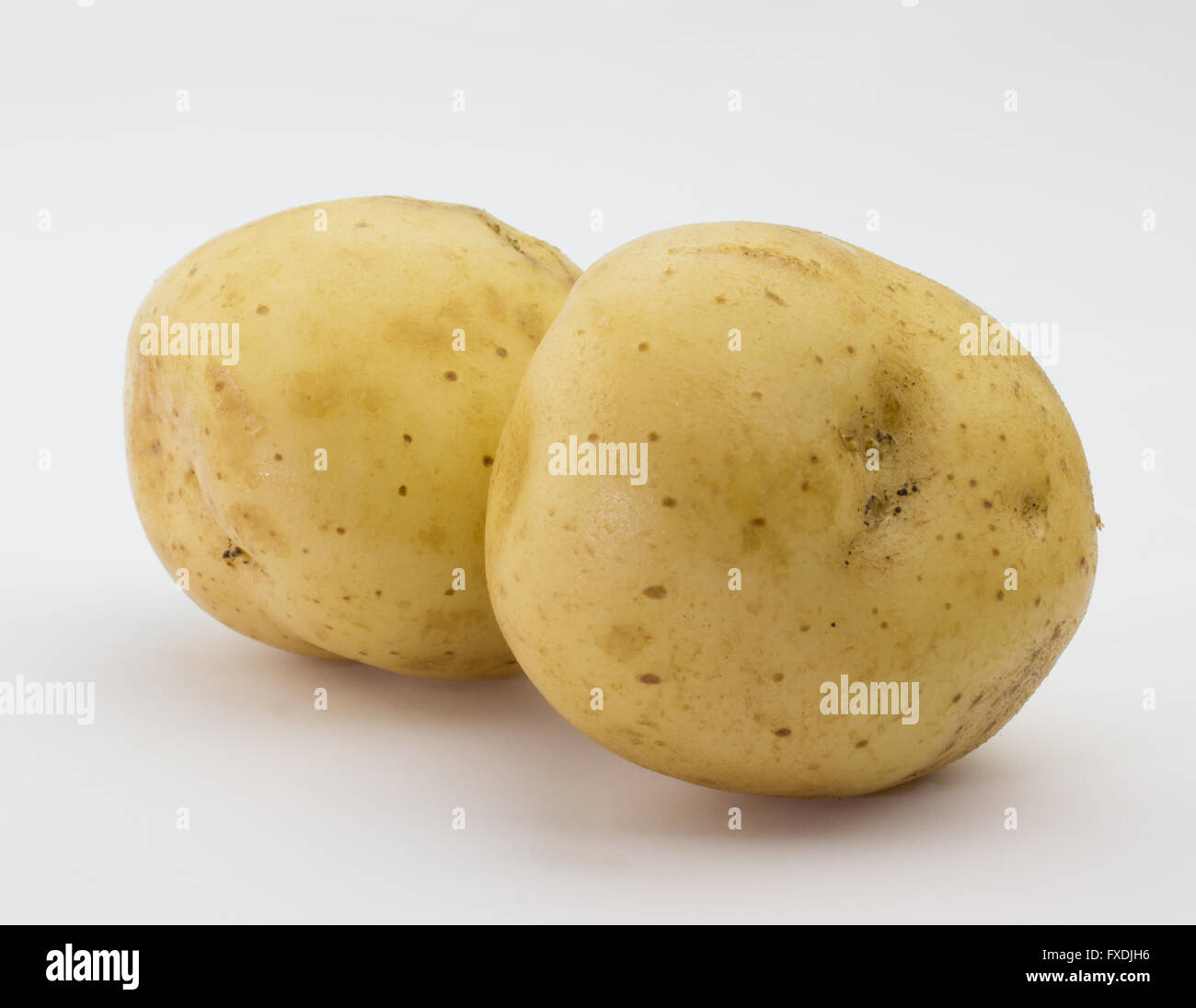 Two potatoes isolated on white background Stock Photo - Alamy
