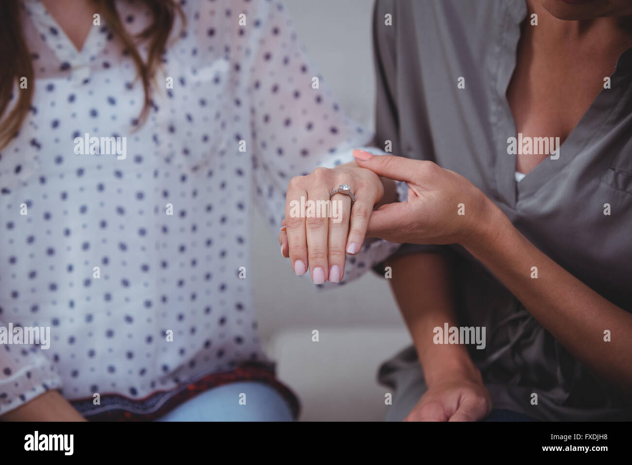 Mid section of women holding hands Stock Photo - Alamy