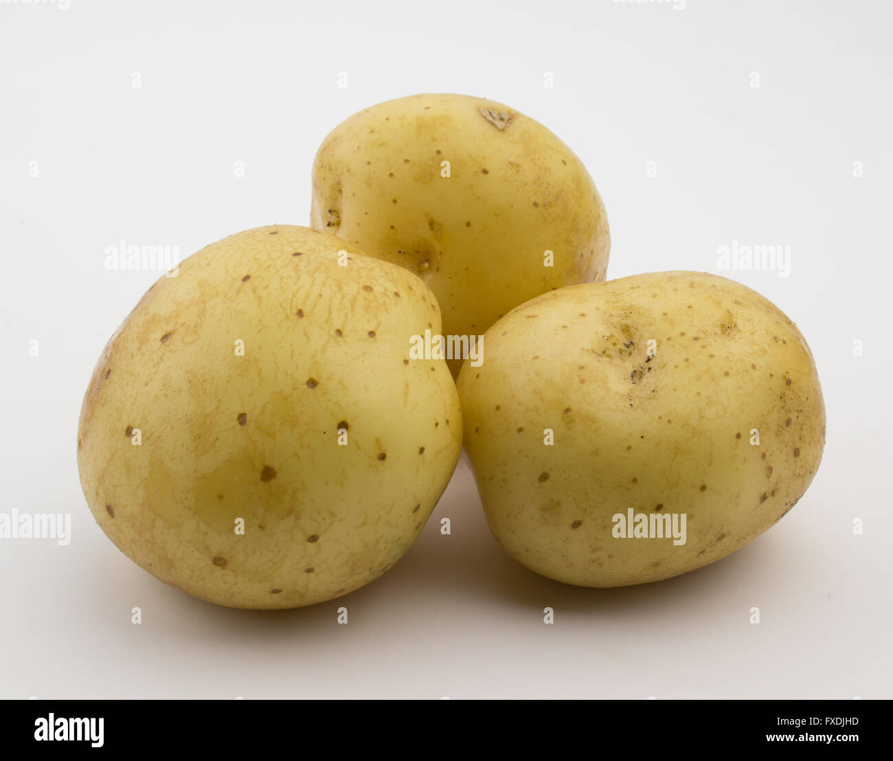 Photo of three potatoes isolated on white background Stock Photo - Alamy