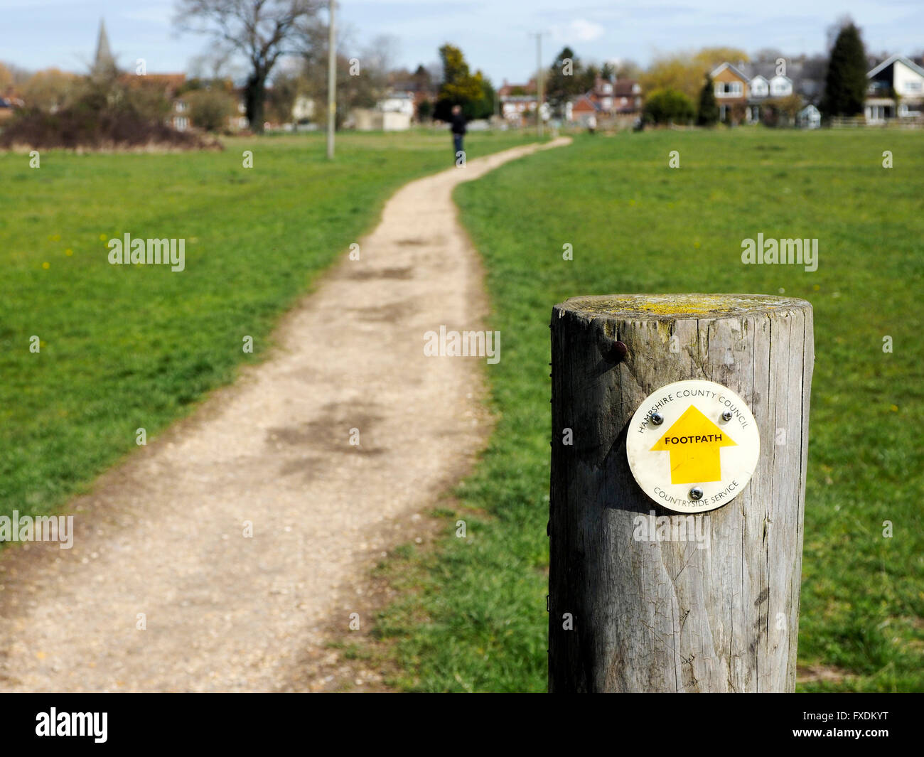 Direction arrow on a post signposting a footpath across water meadows ...