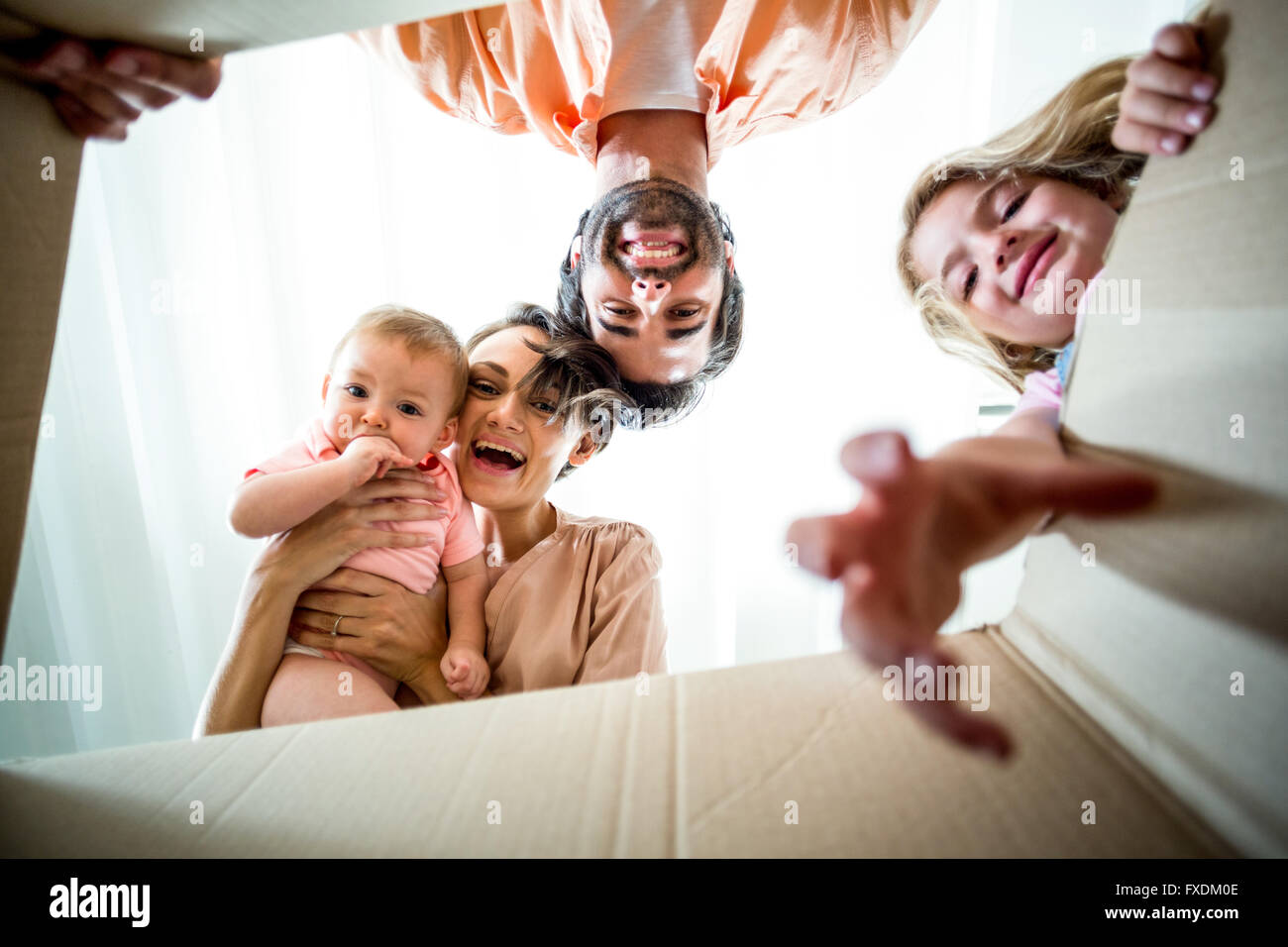 Happy family seen from cardboard box Stock Photo - Alamy