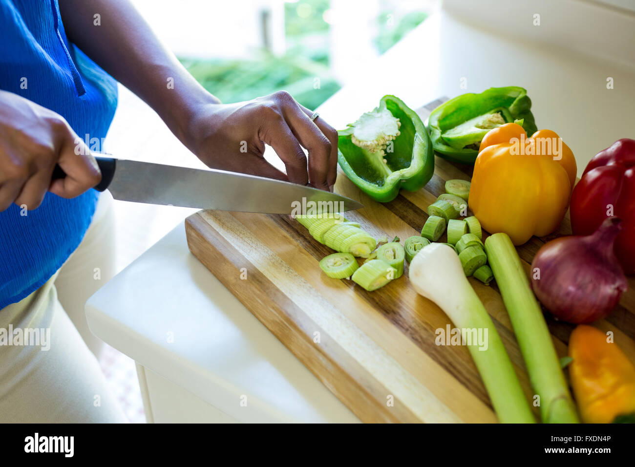 Mid-section of woman chopping vegetable in kitchen Stock Photo - Alamy