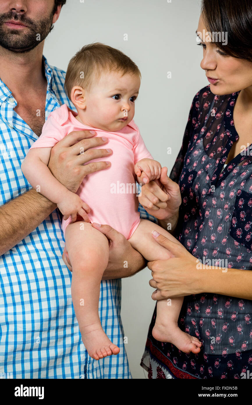 Couple carrying cute baby Stock Photo - Alamy