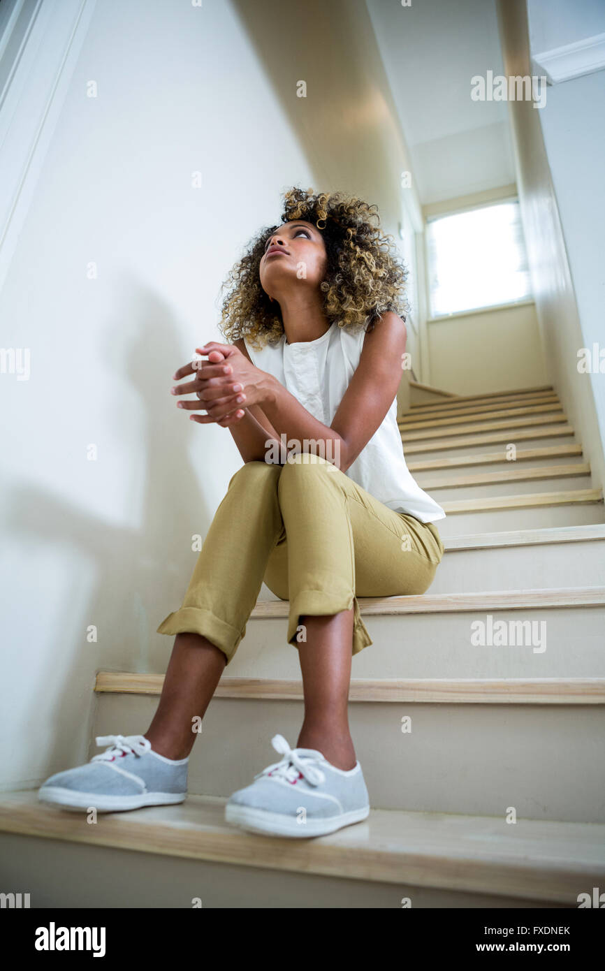 Sad woman sitting on stairs hi-res stock photography and images - Alamy