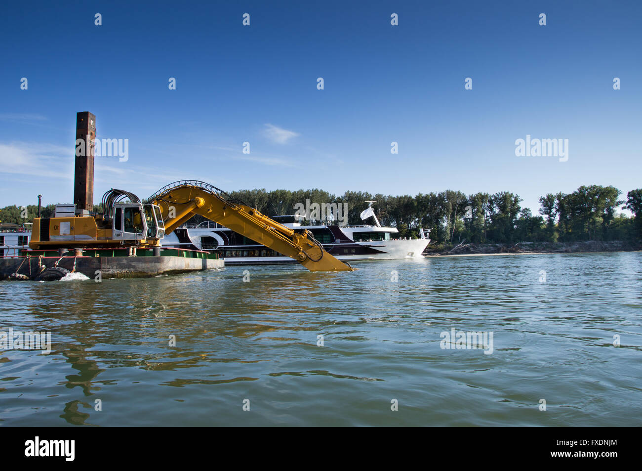 Digger and Cruise Ship at the Danube Stock Photo - Alamy