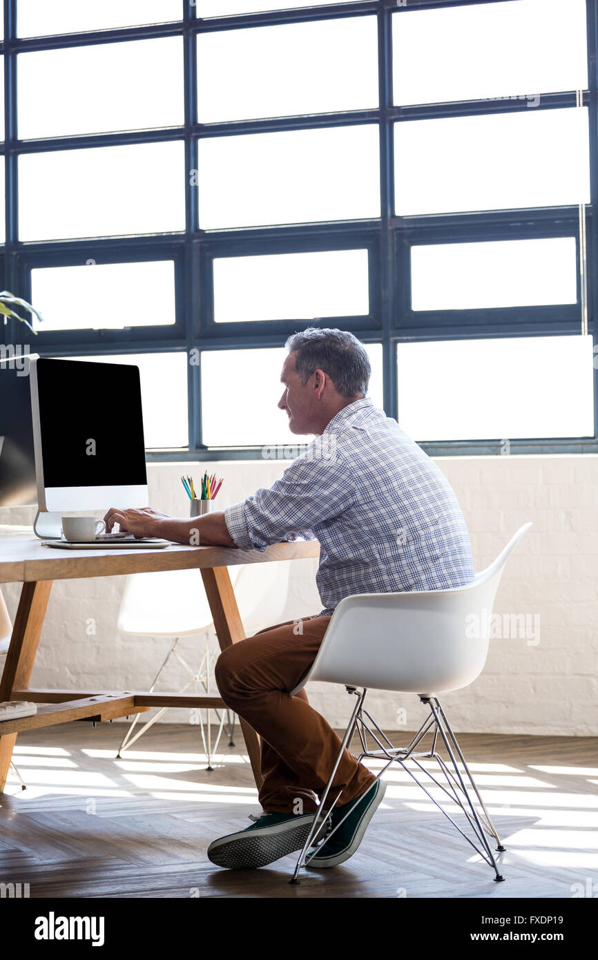 Man working on computer in office Stock Photo - Alamy