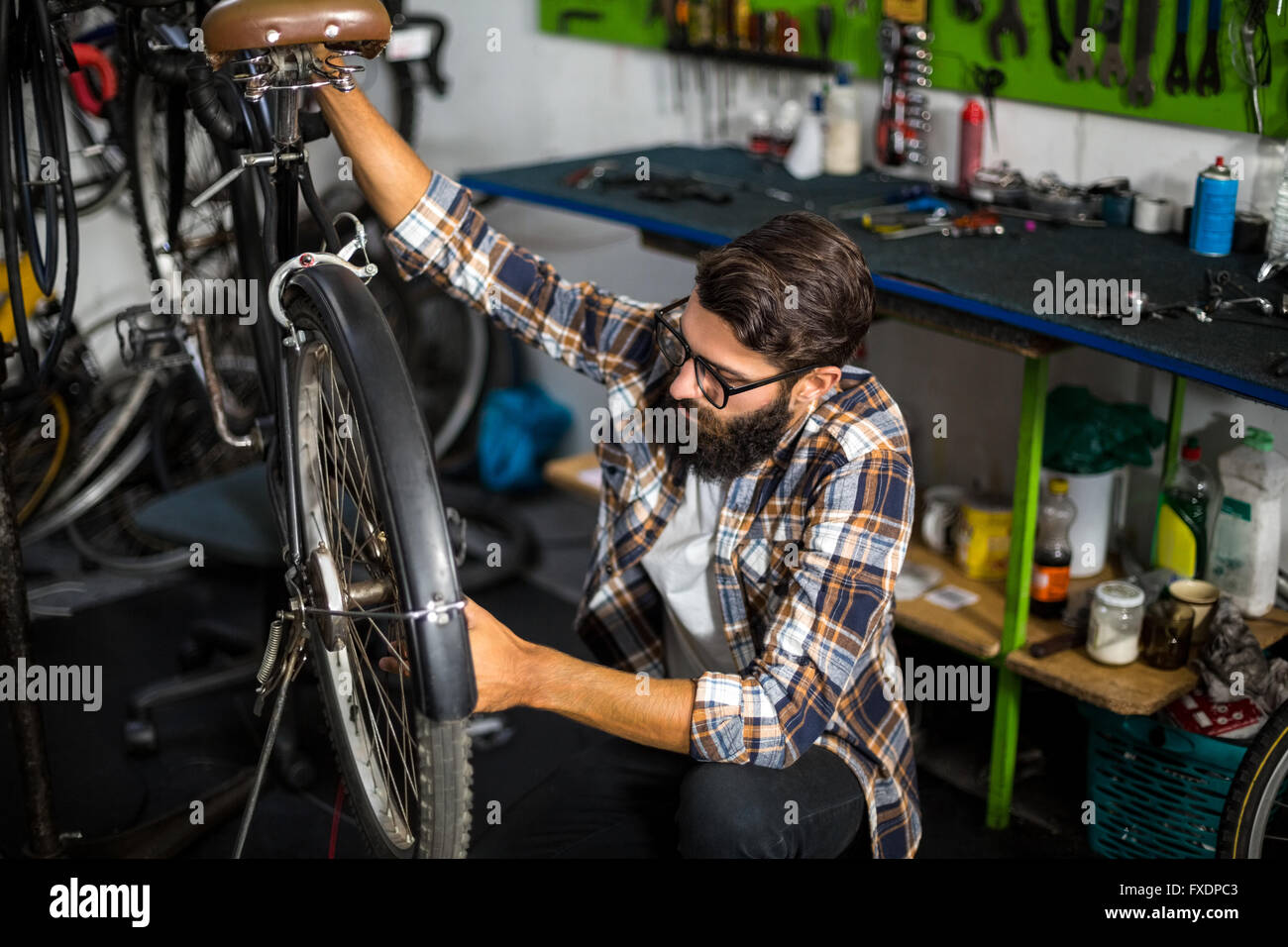 Bike mechanic checking at bicycle Stock Photo - Alamy