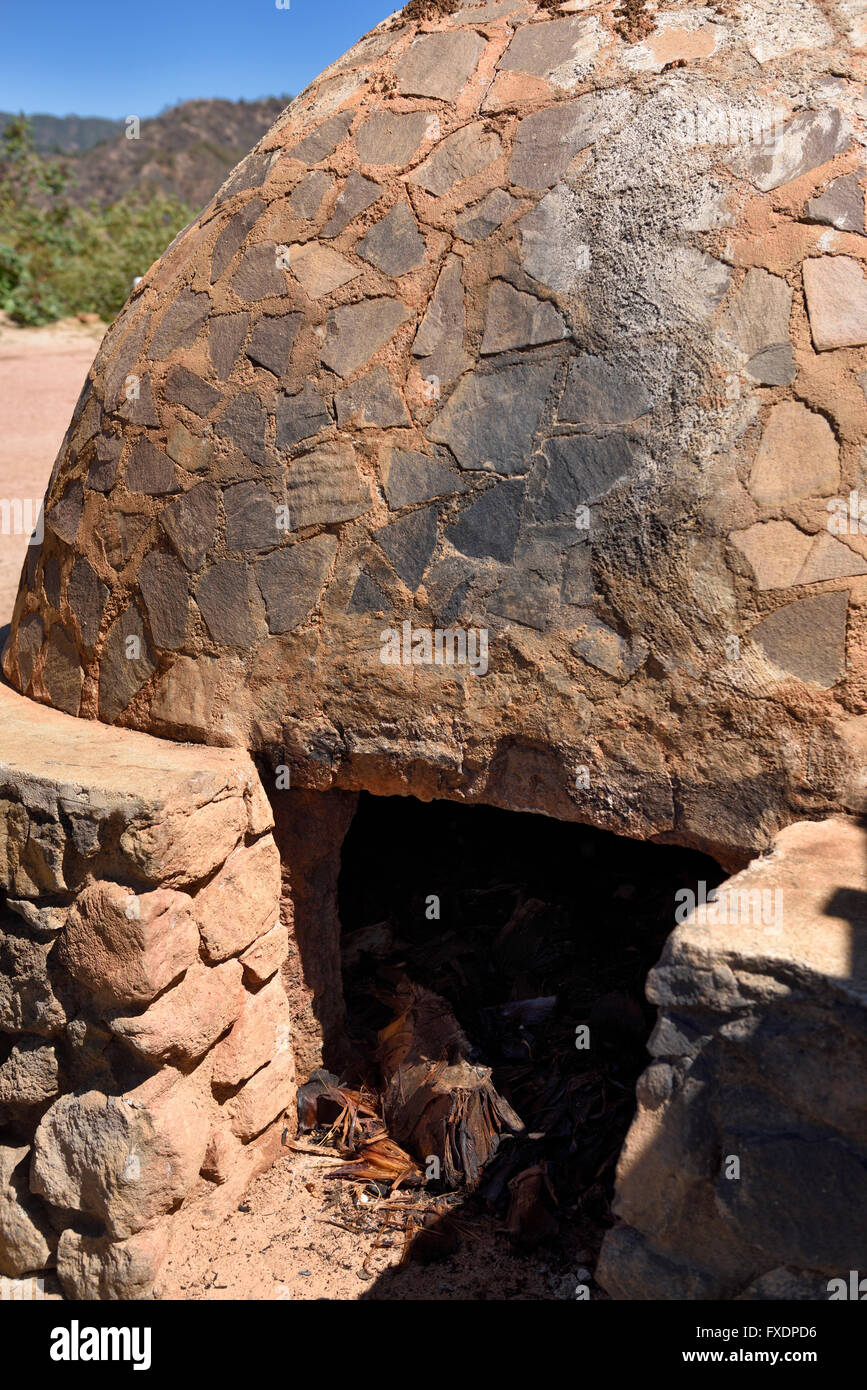 Stone oven for cooking agave hearts at a tequila factory Jelisco Mexico ...