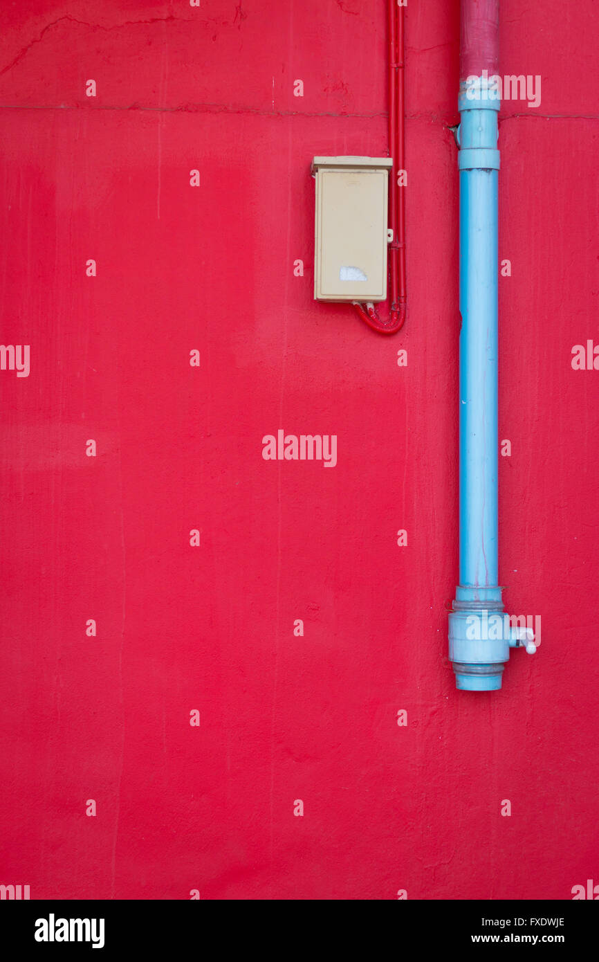 urban red wall texture with water pipe and electrical control box ...