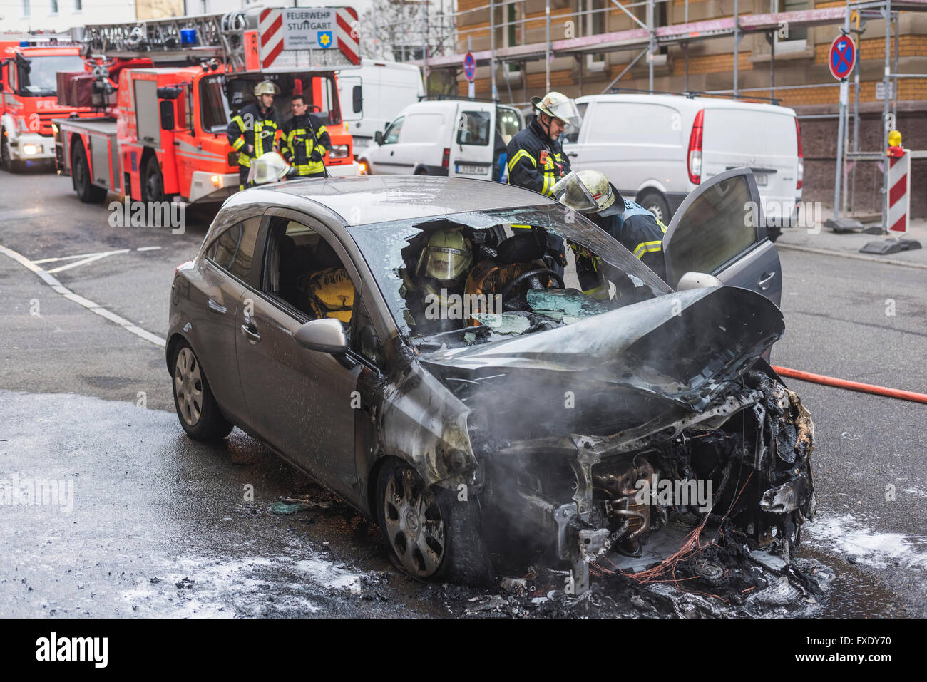 Fire department extinguishing a burning Corsa, burnt engine compartment ...