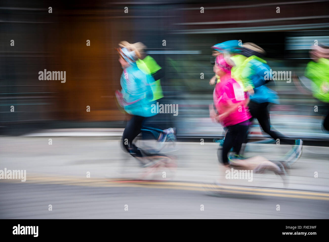 motion blur: a group of women running jogging exercising keeping fit ...