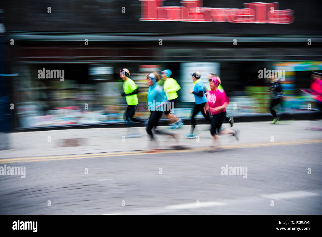 motion blur: a group of women running jogging exercising keeping fit ...
