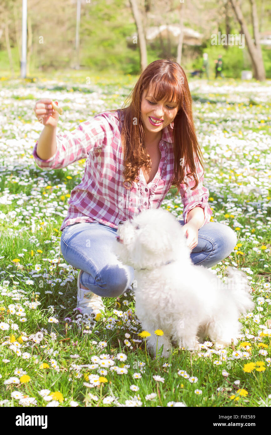 Happy beautiful young woman, enjoying nature with her dog, at sunny ...
