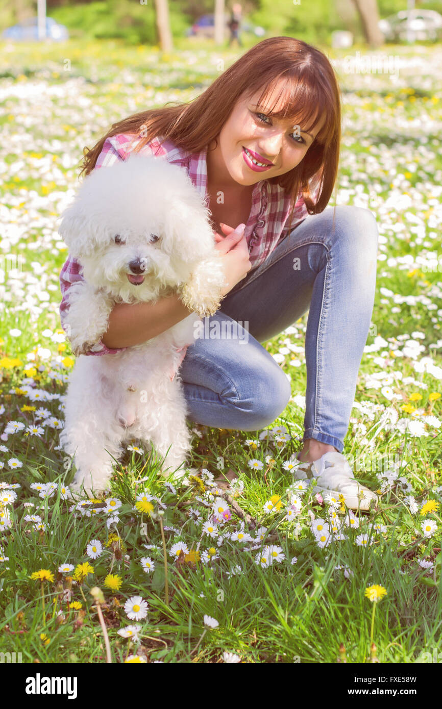 Happy beautiful young woman, enjoying nature with her dog, at sunny ...